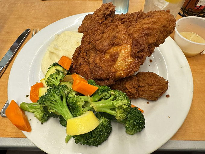 Fried chicken that's audaciously crispy on the outside, tender within, and served with vegetables that didn't just give up and become afterthoughts.