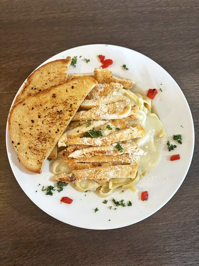 Fettuccine Alfredo with grilled chicken slices – proof that Sandy's isn't just a breakfast virtuoso but plays a full culinary orchestra throughout the day.