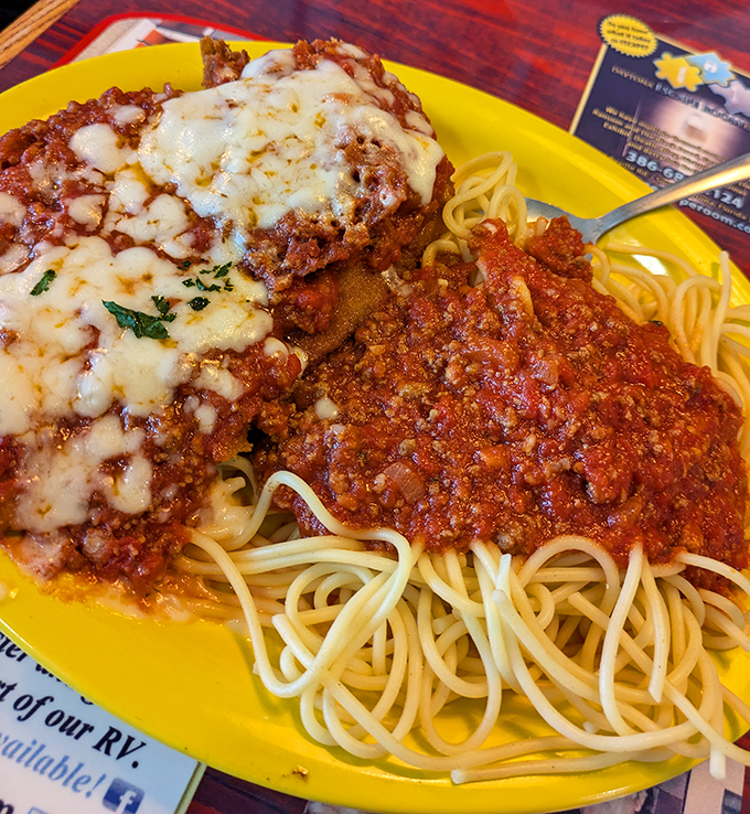 Spaghetti and meatballs on a sunshine-yellow plate – where the sauce sings with slow-simmered tomatoes and the cheese stretches with each twirl of your fork.