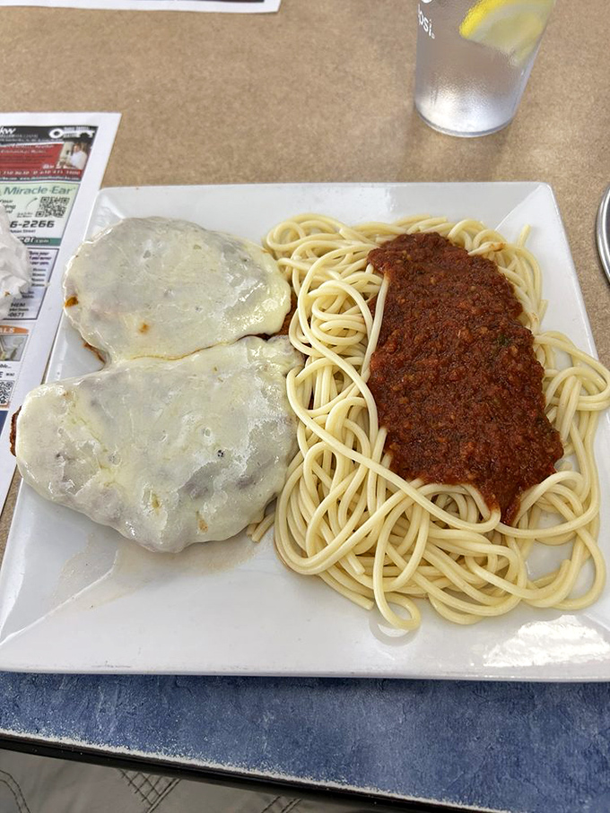 Chicken parmigiana that doesn't mess around &ndash; tender cutlets blanketed in melted cheese alongside a tangle of spaghetti waiting for its close-up.