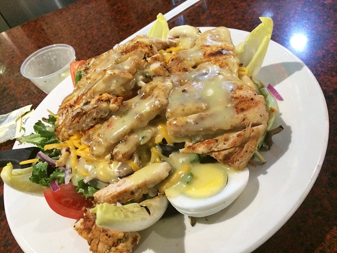 A chicken salad that doesn't hide in mayo but proudly displays its grilled credentials atop a garden of greens and hard-boiled egg sentinels.