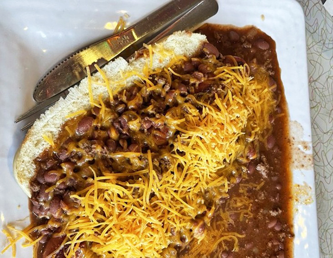 Chili cheese perfection that requires both fork and napkins. This hearty bowl of house-made chili topped with melted cheese demands your full attention.