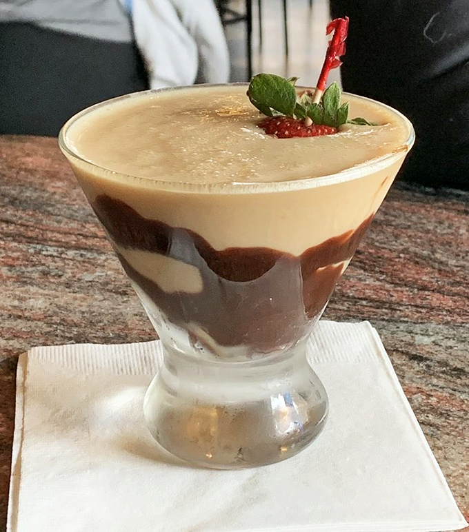 Dessert in liquid form! This chocolate martini layers decadence like a trifle in a glass. The strawberry garnish isn't fooling anyone&mdash;this is pure indulgence.