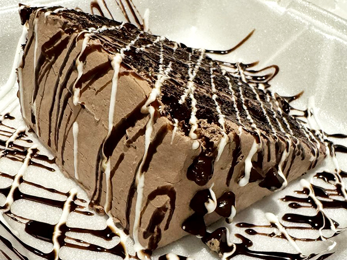 This chocolate cake doesn't just end a meal – it punctuates it with an exclamation point of cocoa bliss drizzled with artistic abandon.