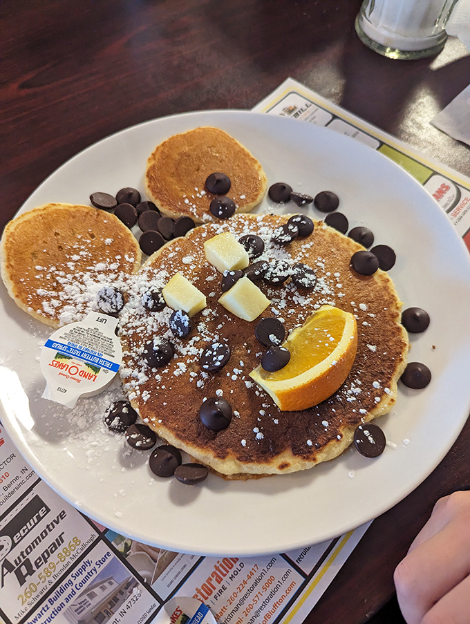Mickey Mouse never looked so delicious&mdash;chocolate chip pancakes dusted with powdered sugar and a smile made of butter and fruit.