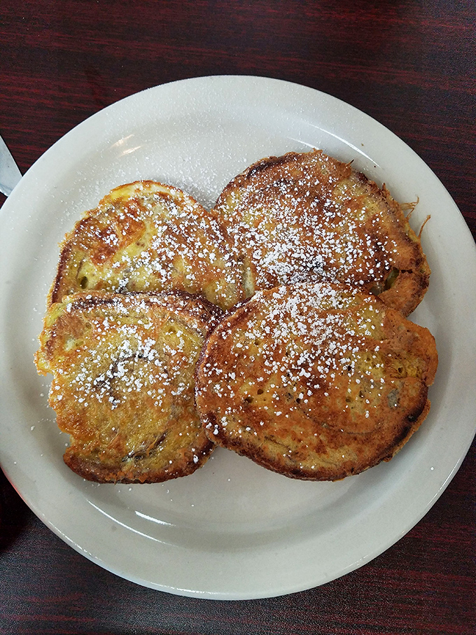 Cinnamon French toast dusted with powdered sugar &ndash; breakfast that boldly crosses into dessert territory without apology.