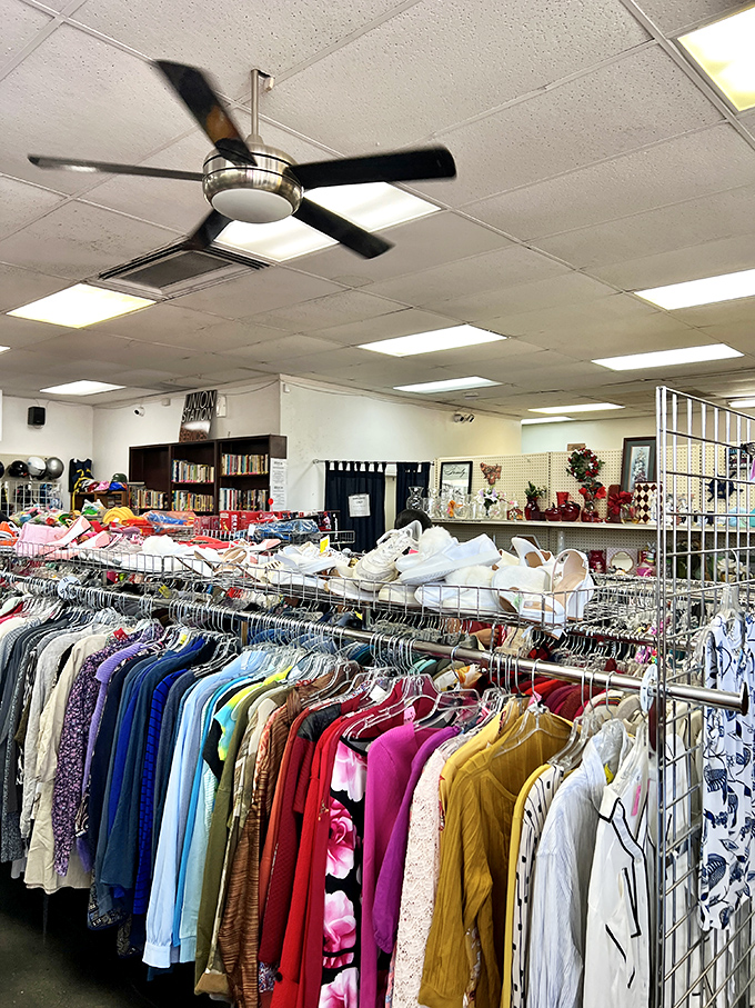 Ceiling fans circulate possibilities while shoppers browse through meticulously organized clothing racks sorted by type rather than brand.