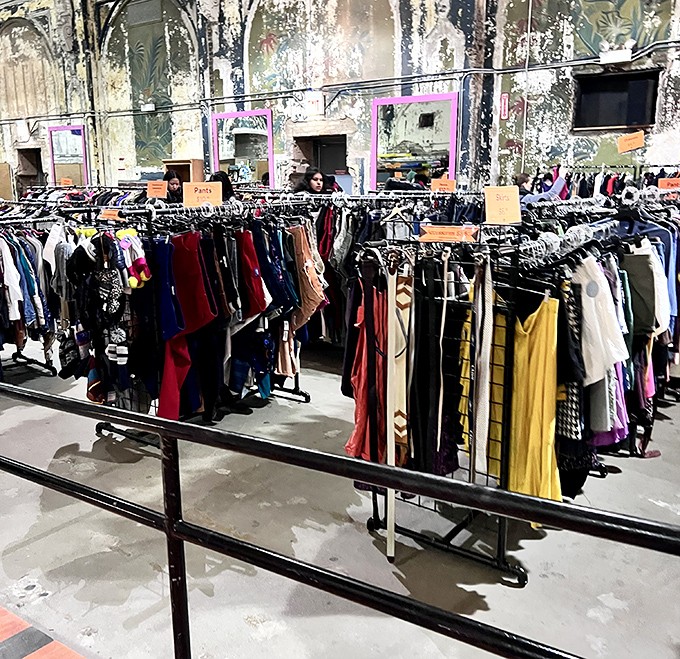 Clothing racks stretching into infinity, where every color tells a different decade's fashion story beautifully.