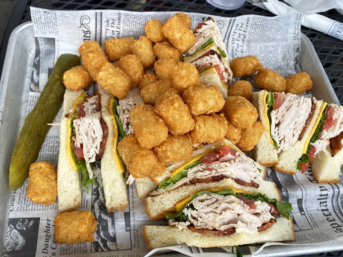 The club sandwich and tater tots combo &ndash; proof that sometimes the classics endure because they're simply unbeatable, especially on newspaper-lined baskets.