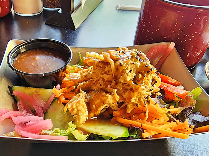 This isn't just a salad&mdash;it's a crunchy, colorful celebration topped with what appears to be crispy chicken and served with a side of satisfaction.
