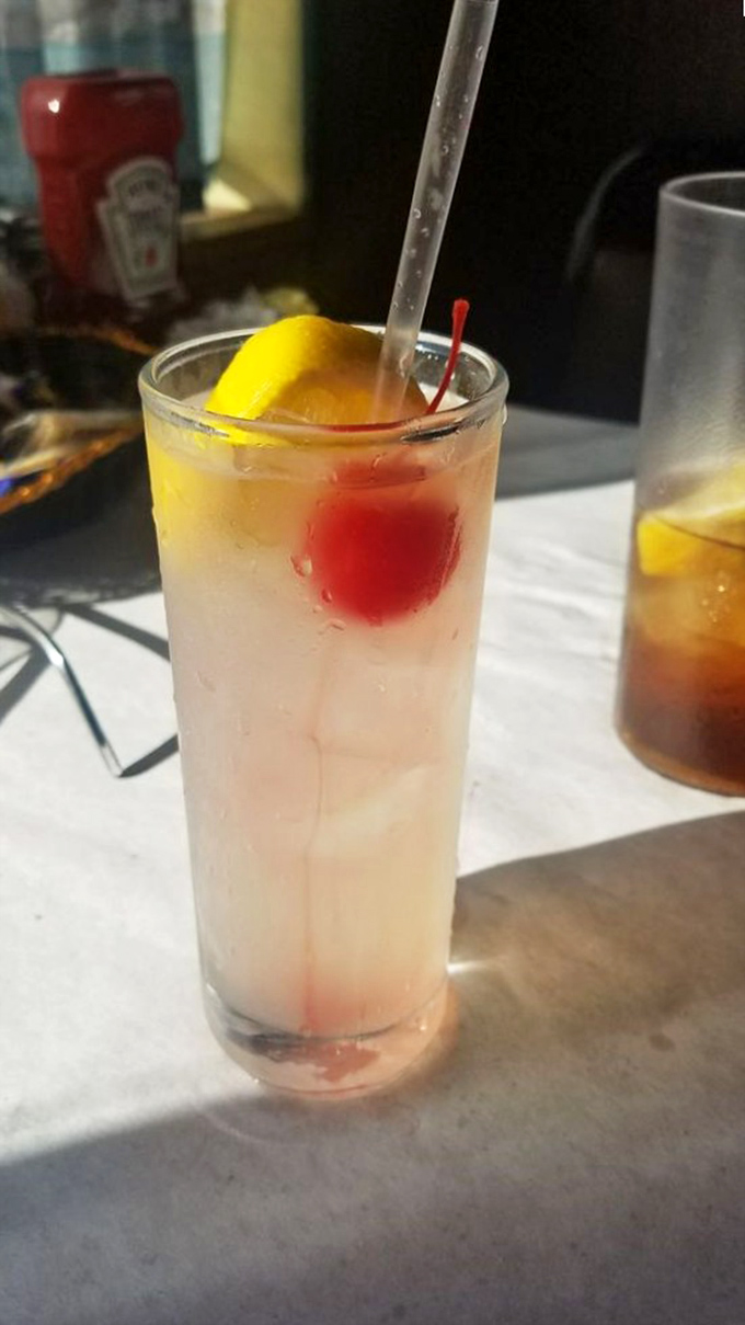 A Tom Collins with that cherry and lemon slice isn't just a drink&mdash;it's the perfect intermission between seafood acts.
