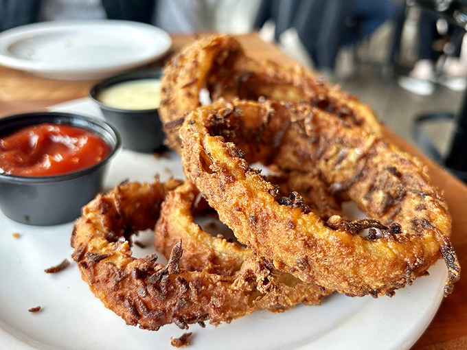 Onion rings with the golden-ratio of crunch-to-sweetness. Those dipping sauces aren't just condiments &ndash; they're flavor destiny.