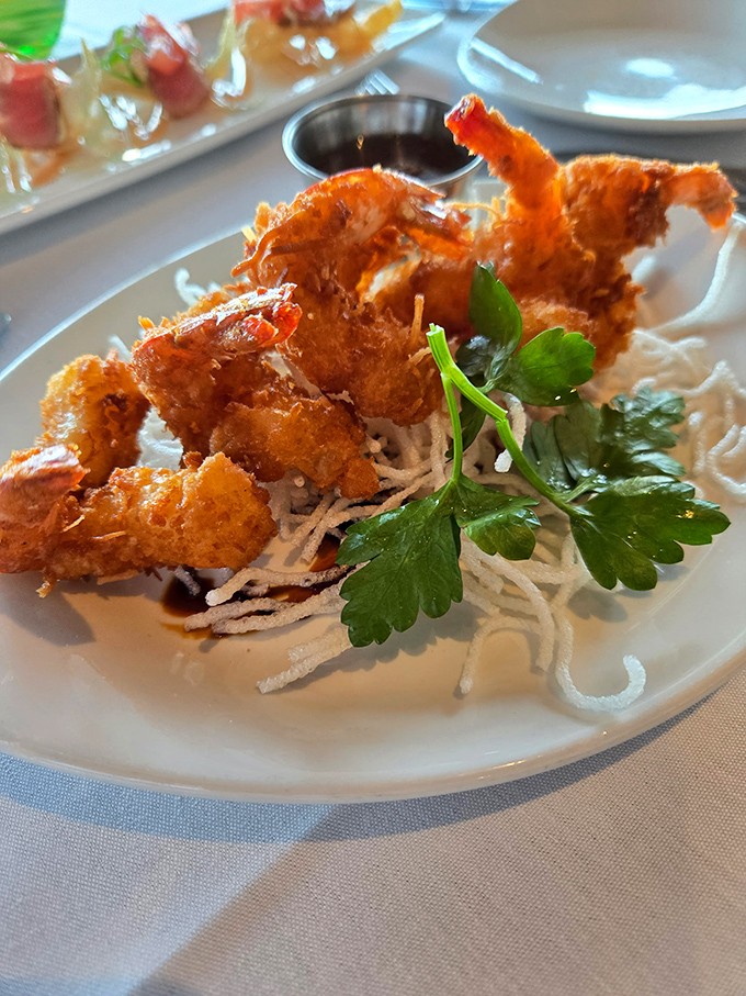 Coconut shrimp that crunch louder than your diet plan being torn to shreds, served with a dipping sauce worth abandoning all self-control for.
