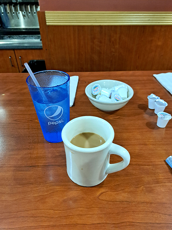 The classic diner duo: bottomless coffee in that iconic thick mug alongside a Pepsi that's so blue it could be in a jewelry commercial.