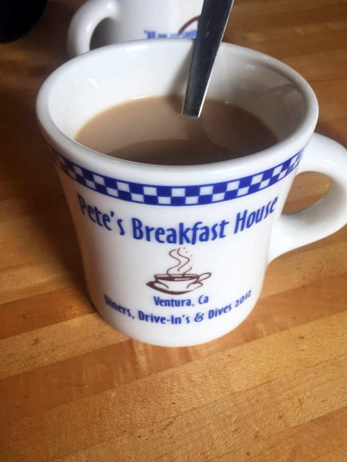 The blue-checkered coffee mug &ndash; a humble vessel for liquid motivation and the unofficial mascot of morning victory.
