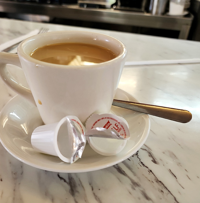 Coffee served with those little creamer cups&mdash;proof that sometimes the simplest pleasures are the most satisfying.