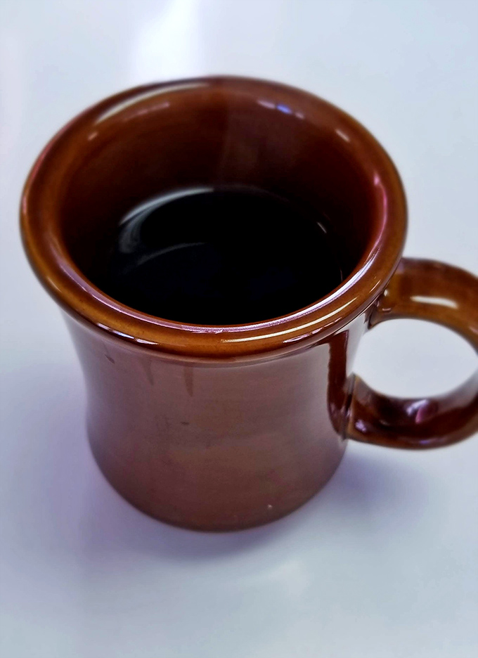 The humble brown mug holds coffee that doesn't need fancy Italian names or artisanal foam&mdash;just honest caffeine that gets the job done.