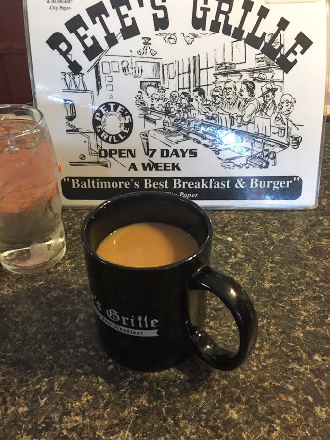 The unofficial mascot of Pete's Grille: a sturdy black coffee mug that promises to keep refilling until you've solved all the world's problems.
