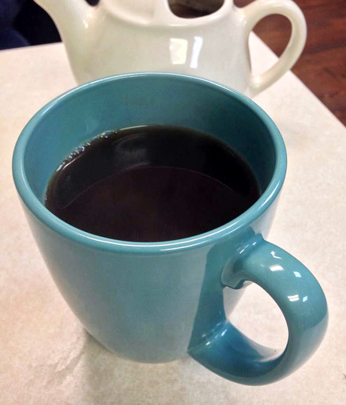 That turquoise mug isn't just serving coffee&mdash;it's delivering liquid motivation in a vessel that matches the diner's cheerful aesthetic.