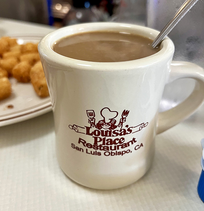 The official chalice of morning salvation, emblazoned with the Louisa's logo&mdash;because coffee this good deserves its own coat of arms.