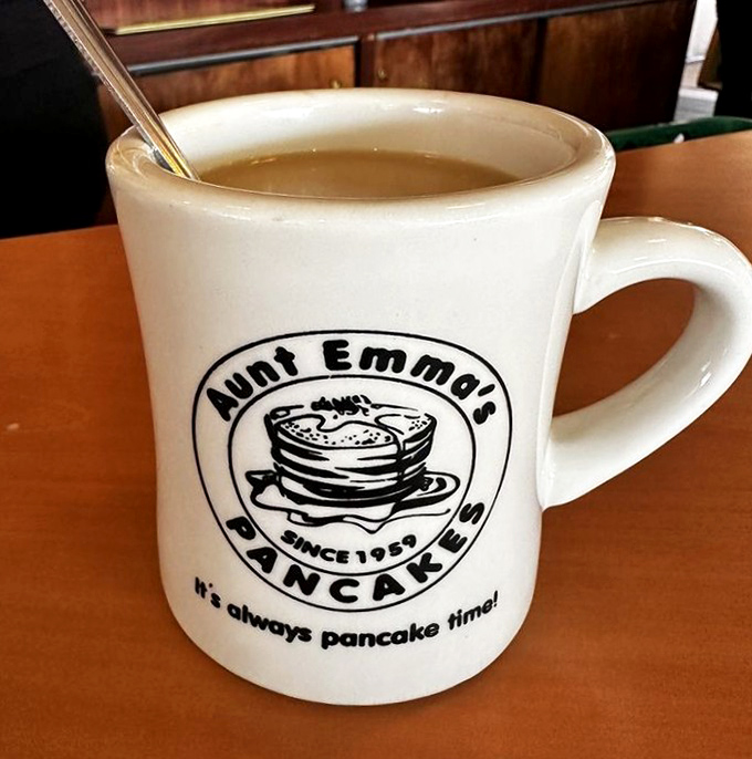 The mug that launched a thousand mornings. Strong diner coffee in a classic ceramic vessel proudly proclaiming what this place does best&mdash;it's always pancake time indeed! 