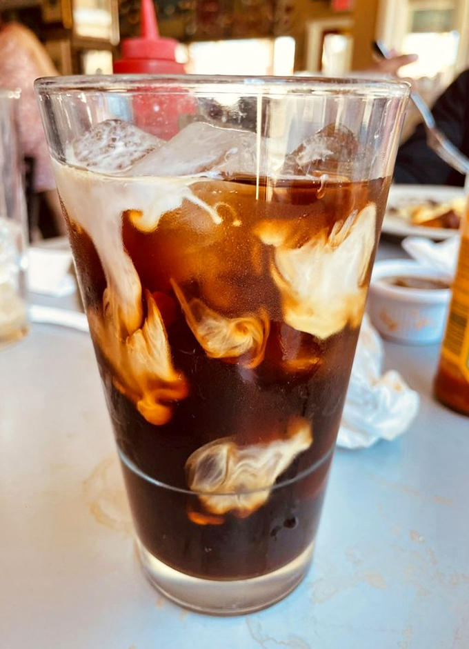 The cafe's cold brew with cream swirls like a caffeinated work of art&mdash;the perfect companion for contemplating your next menu selection.