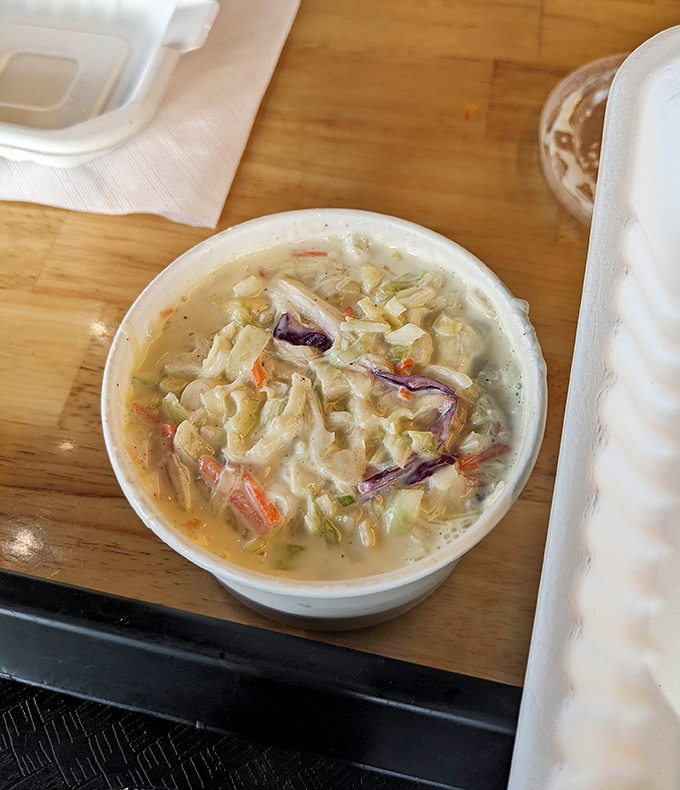 Creamy coleslaw that doesn't just accompany the meal but completes it—the cool, crunchy counterpoint to all that glorious fried goodness.