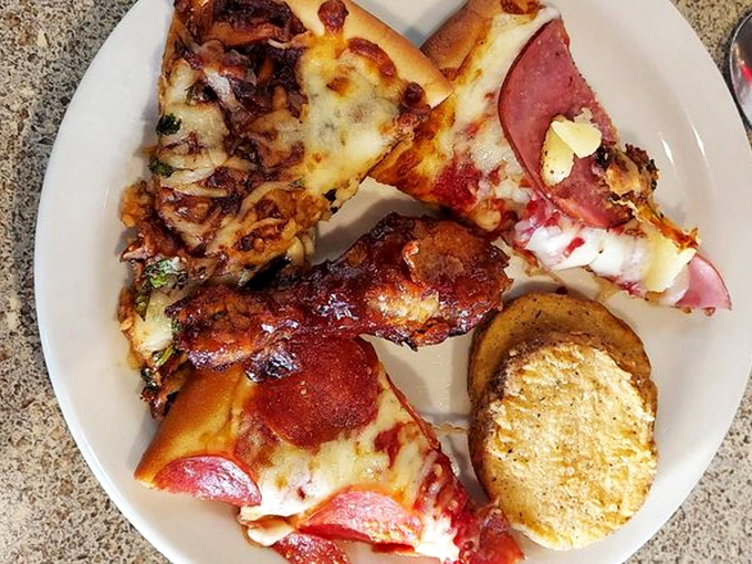 Pizza and chicken on one plate? This isn't indecision&mdash;it's brilliant buffet strategy. The golden garlic bread is the supporting actor stealing the scene.