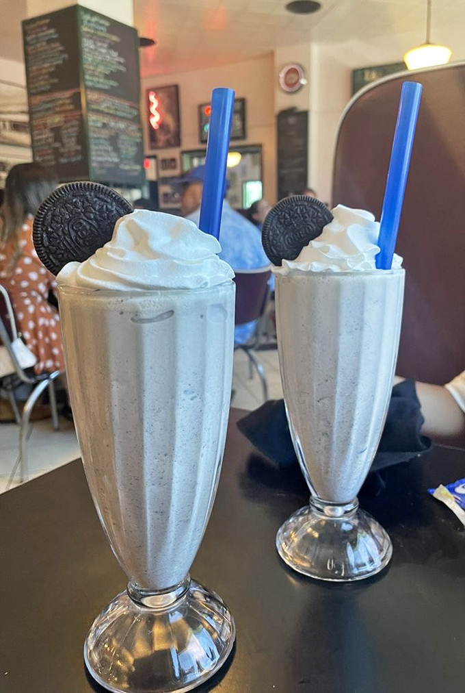 Milkshakes thick enough to require serious straw commitment, crowned with Oreos like the royalty they are. Worth every calorie and brain freeze.