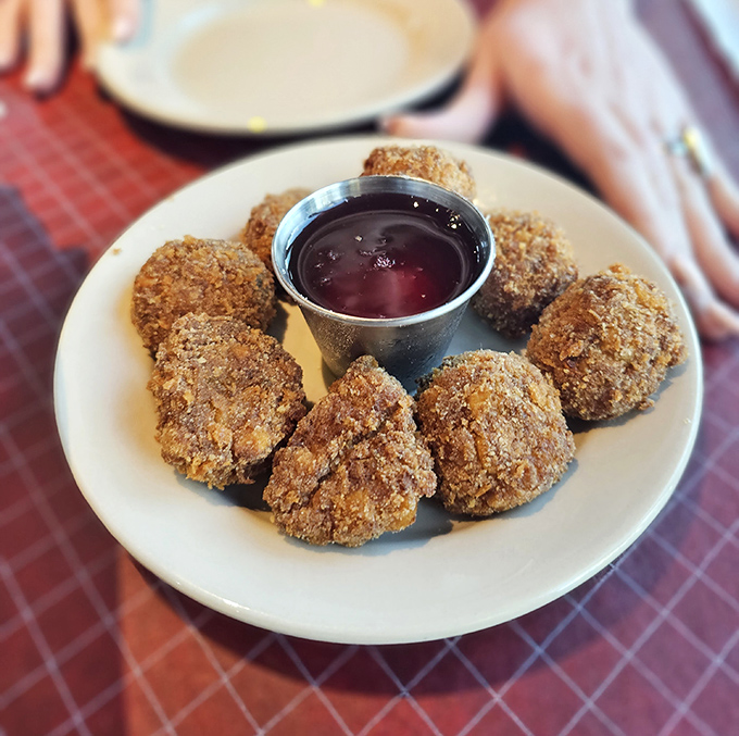 Crispy, golden corn fritters surround a dipping sauce like planets orbiting a delicious sun. Appetizers that make you question why we even have main courses.