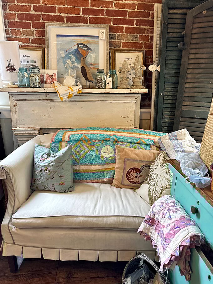 A perfectly staged vignette &ndash; the white sofa with coastal pillows whispers stories of summer homes and weekend getaways.