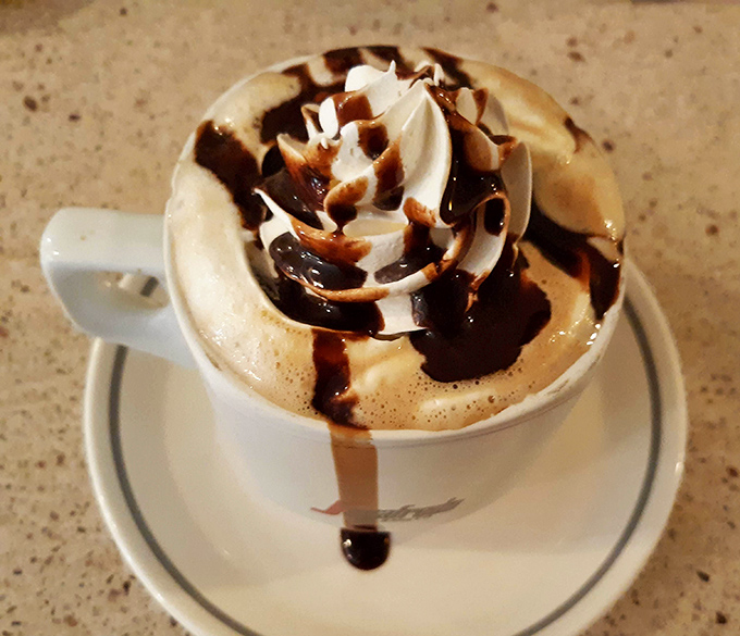 Coffee art so pretty you almost don't want to drink it&mdash;almost. The chocolate drizzle is just showing off at this point.