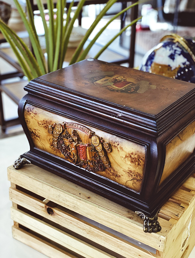 A mysterious wooden box with classical scenes&mdash;perfect for storing secrets, treasures, or those chocolate cookies you're hiding from everyone else.