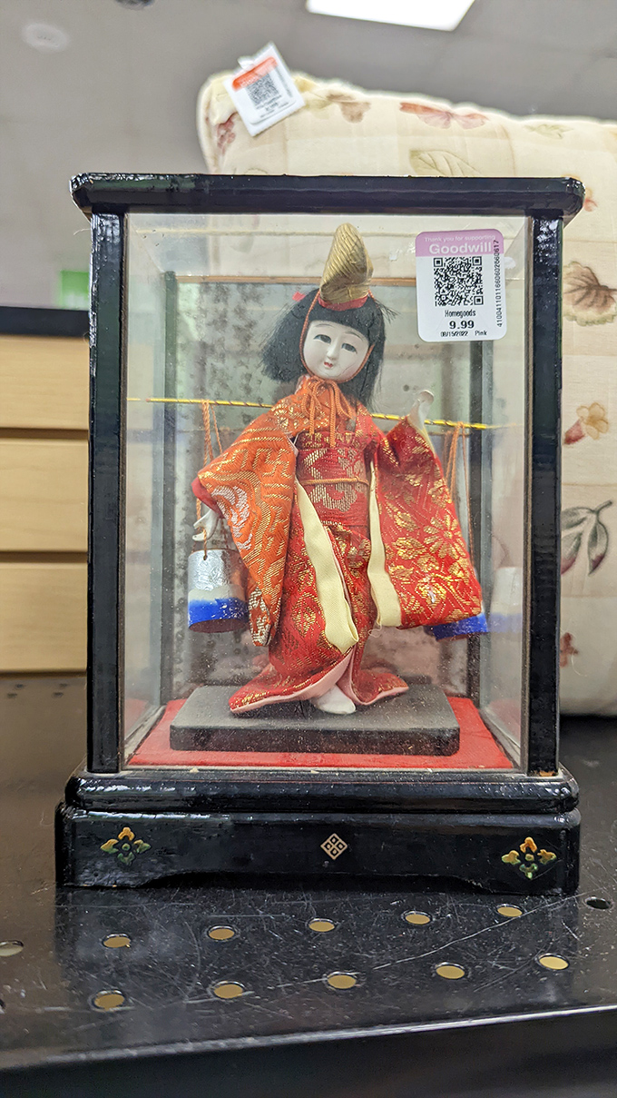 A delicate Japanese doll in traditional kimono attire &ndash; someone's cherished keepsake now awaiting its second chapter.