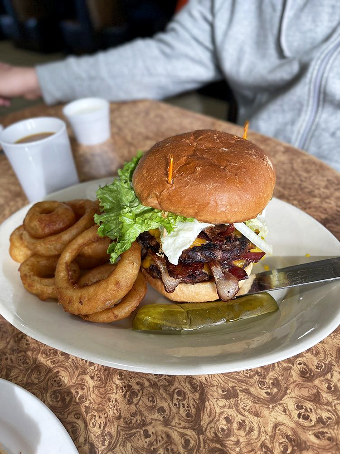 This isn't just a burger &ndash; it's architecture. The golden ratio of beef to bacon to cheese, with onion rings standing guard like delicious sentinels.
