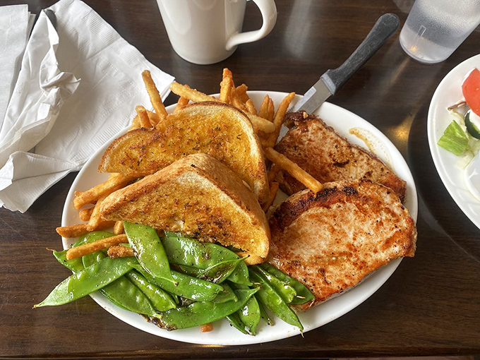 These pork chops aren't just cooked&mdash;they're respected. Paired with snap peas that actually snap and toast that's achieved golden greatness.