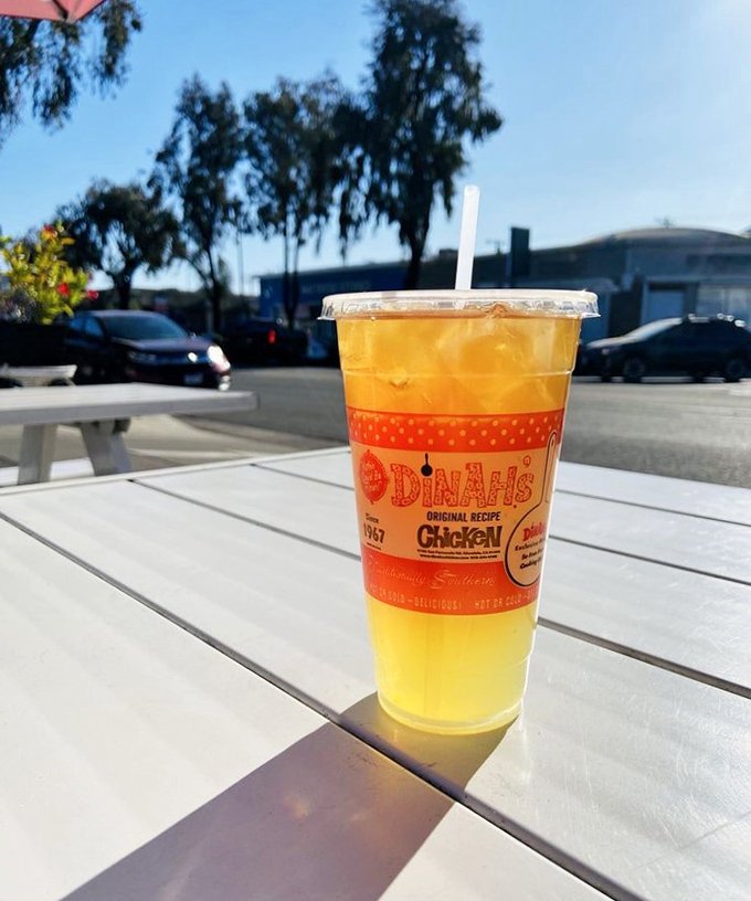 Their signature pineapple iced tea, served in a branded cup, offers the perfect sweet counterpoint to all that savory fried goodness.