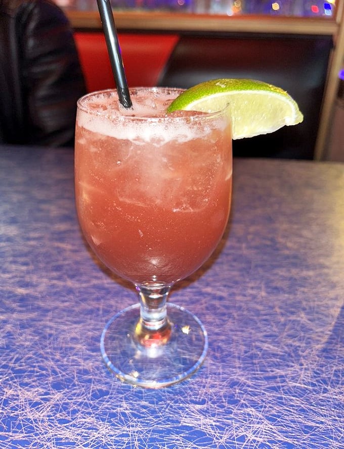 This isn't just a cocktail; it's summer in a glass, complete with the kind of color that makes your Instagram followers double-tap with envy.