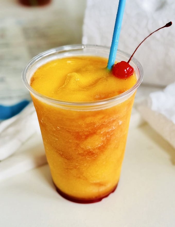 That golden-orange frozen concoction isn't just a drink&mdash;it's liquid sunshine with a cherry on top. Florida in a glass.