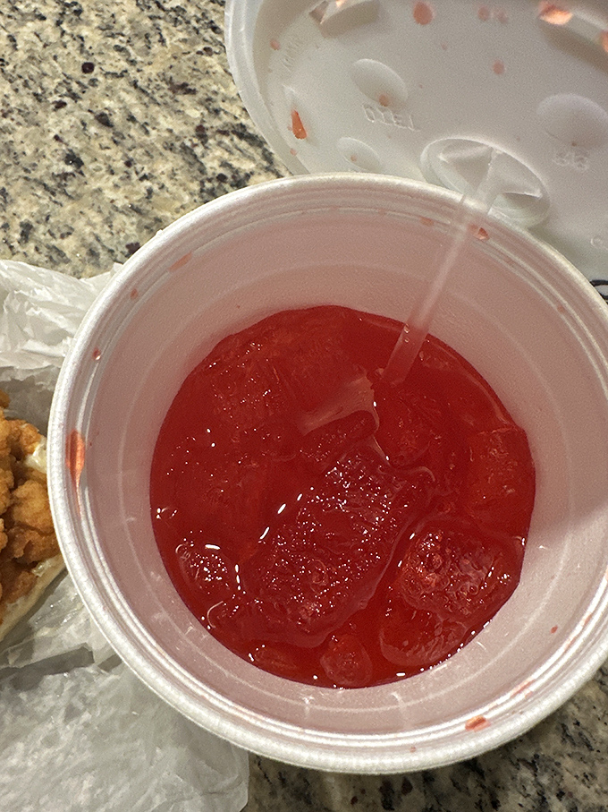 Even the drinks come with a side of nostalgia. That ruby-red sweetness in a plastic cup is the perfect counterpoint to the savory seafood.