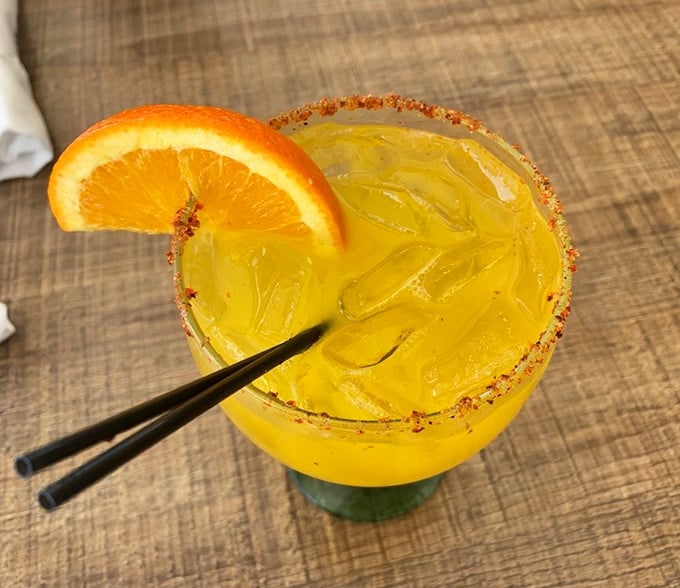 A sunshine-colored cocktail with a chili-salt rim&mdash;Miami in a glass, where every sip feels like a mini vacation.