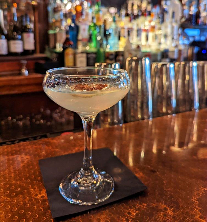 Cocktail artistry at its finest. This crystal-clear martini sits regally at the copper bar, waiting to transform your evening from ordinary to extraordinary.