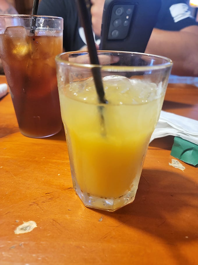 Cold drinks on a worn wooden table&mdash;the universal signal that good conversation and better food are moments away.