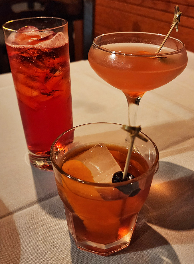 The cocktail trinity: a classic Old Fashioned, something pink and sophisticated, and that ruby-red concoction&mdash;liquid companions for your seafood adventure.