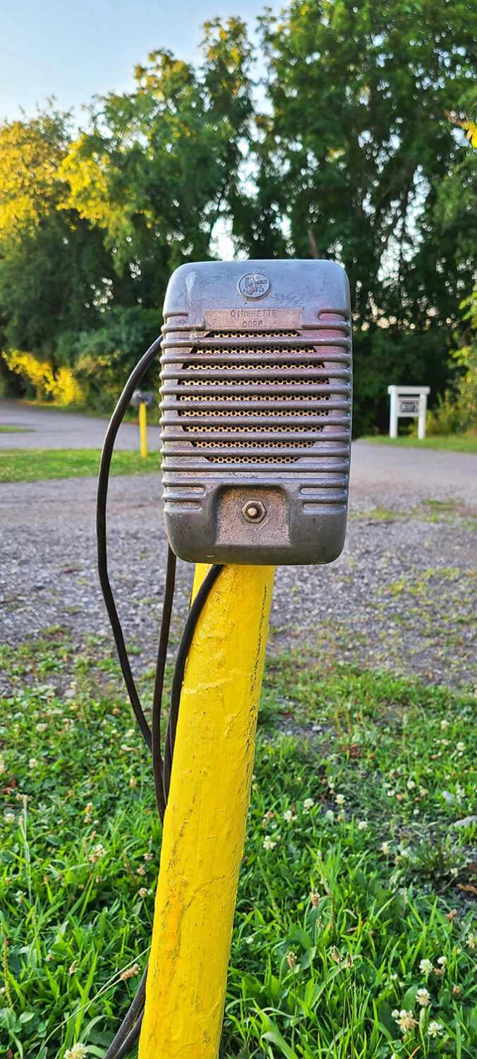 A vintage Cinematone speaker&mdash;the original podcast device&mdash;still standing guard on its yellow post, ready to whisper movie magic.