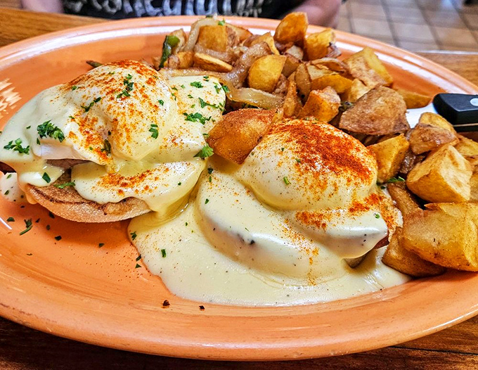 Eggs Benedict reimagined with architectural precision&mdash;hollandaise cascading like a creamy waterfall over perfectly poached eggs and crispy English muffins.