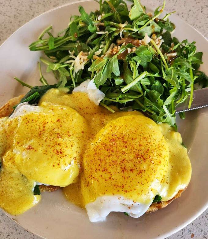 Eggs Florentine with a side of arugula &ndash; because sometimes you need something green to justify the hollandaise sauce party.