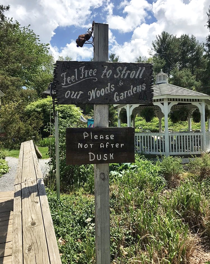 Feel Free to Stroll invites the charming garden sign. Nature and whimsy await beyond the gazebo.