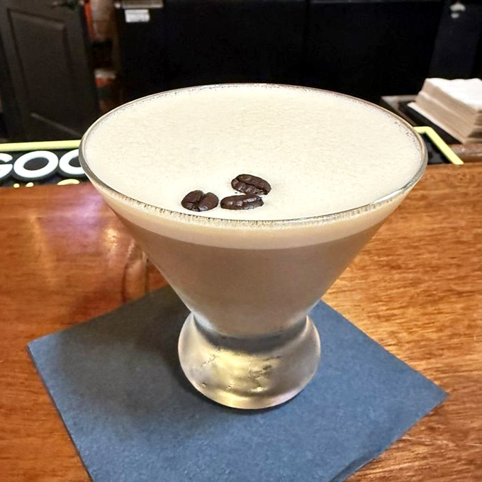 This isn't just a cocktail; it's dessert in a martini glass. Coffee beans float like tiny life rafts on a sea of creamy indulgence.