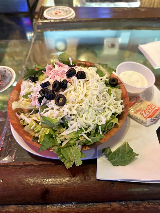 This isn't just a salad&mdash;it's a garden party in a wooden bowl, where cheese and olives mingle with the leafy guests of honor.